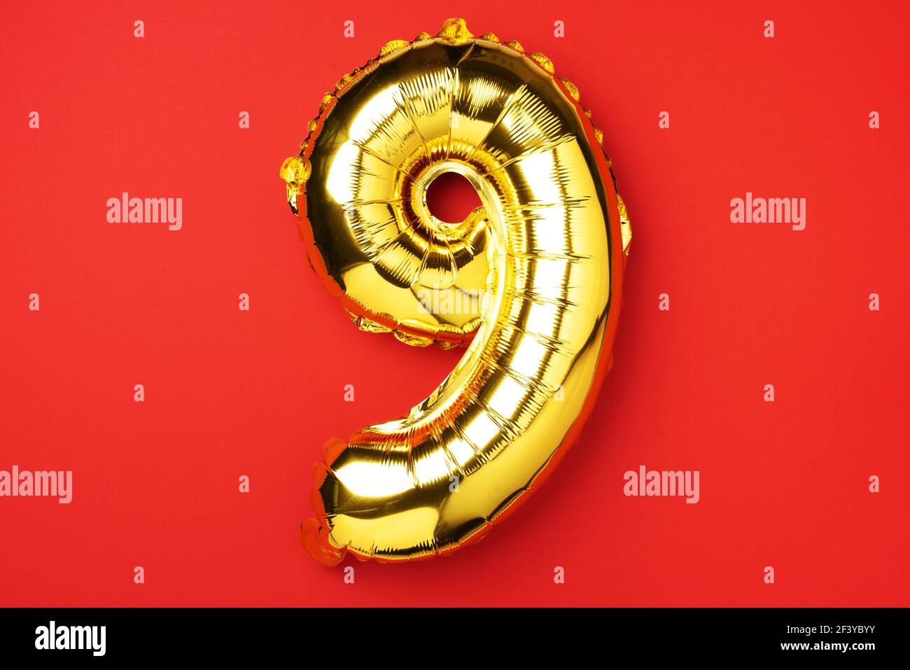 Creative layout. Golden foil balloon number and digit nine 9. Birthday ...