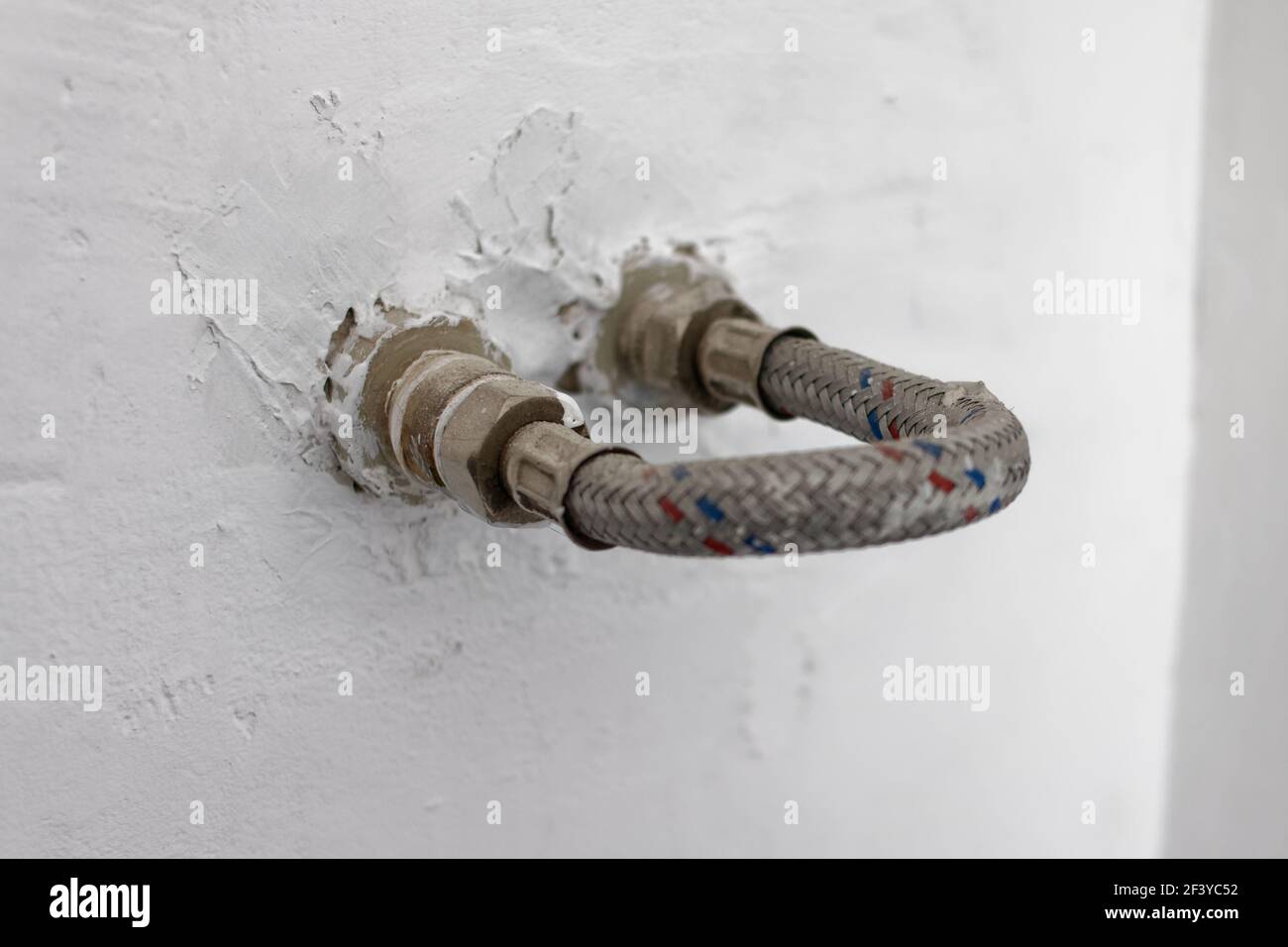 Water supply fittings on the wall Stock Photo - Alamy