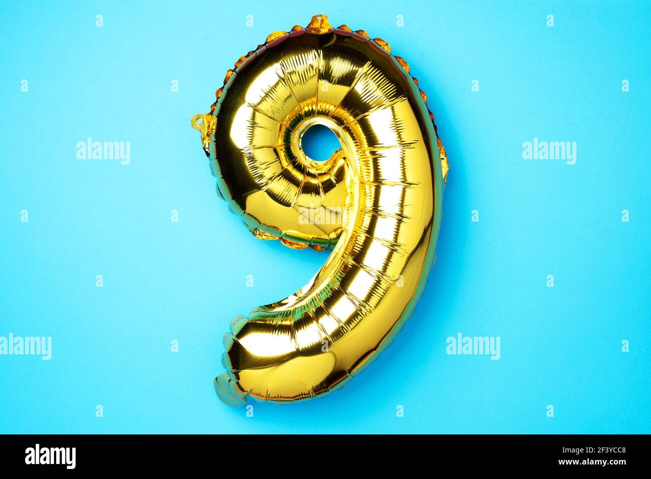 Creative layout. Golden foil balloon number and digit nine 9. Birthday greeting card ...