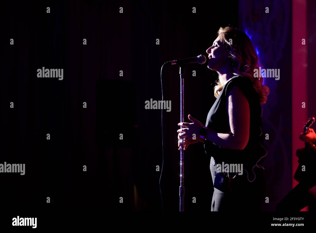 Female singer, performing her vocal sound. With lens flare and ...