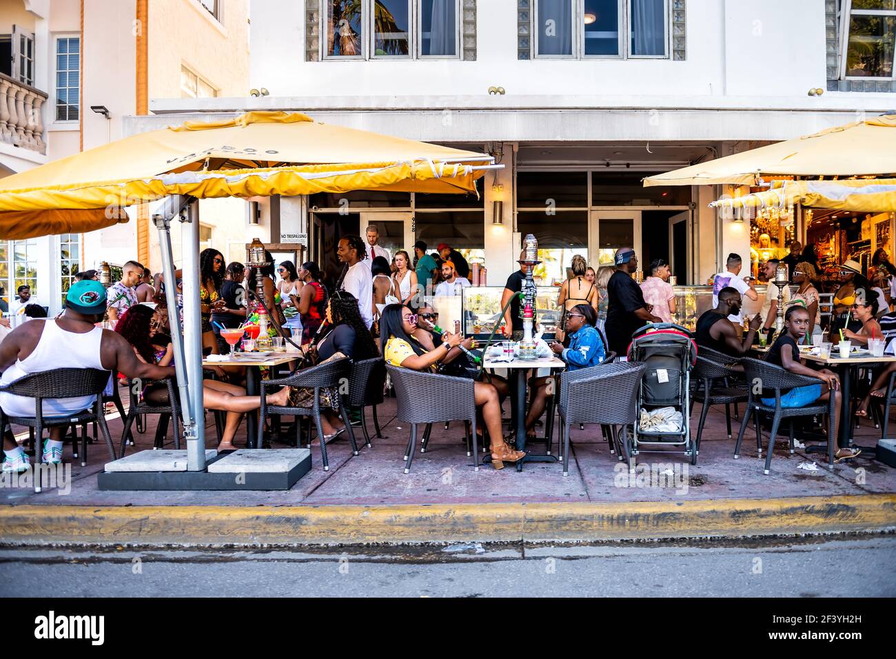 Miami Beach, USA - May 5, 2018: People sitting eating drinking at ...