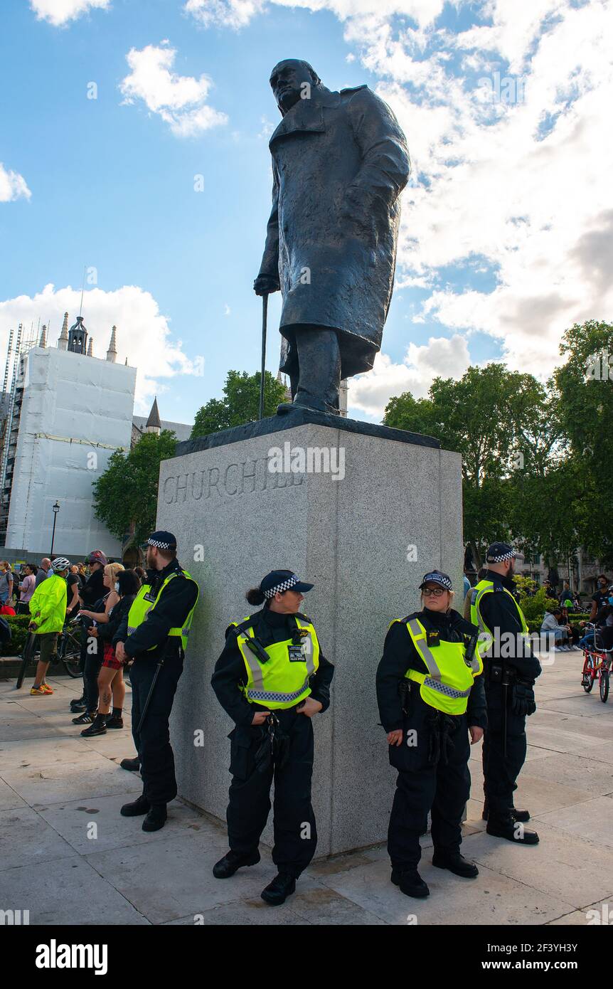 Metropolitan Police officers surrounding the statue of Sir Winston ...