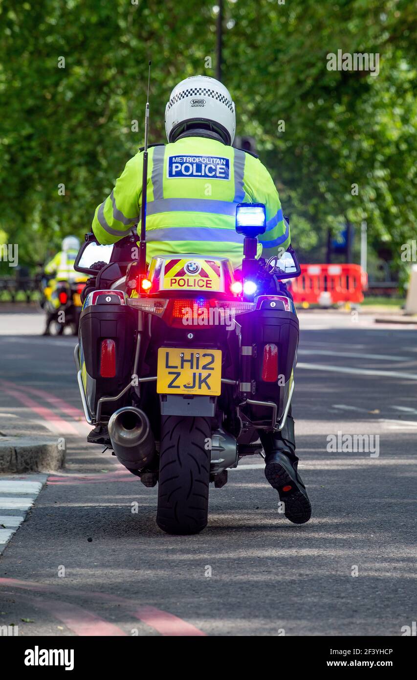 Metropolitan Police motorcycle officer monitoring demonstration ...