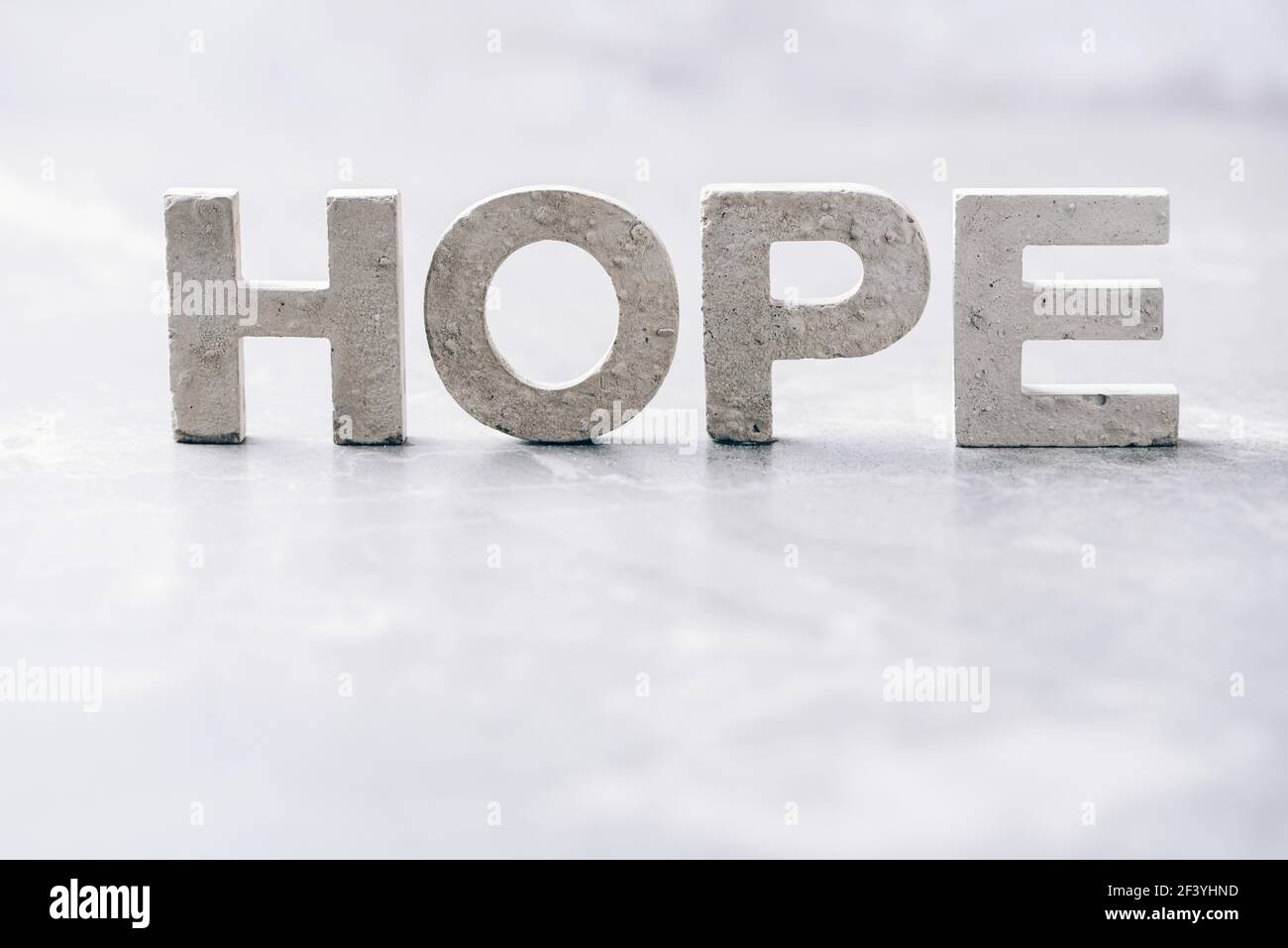 Word HOPE made with cement letters on grey marble background. Copy ...