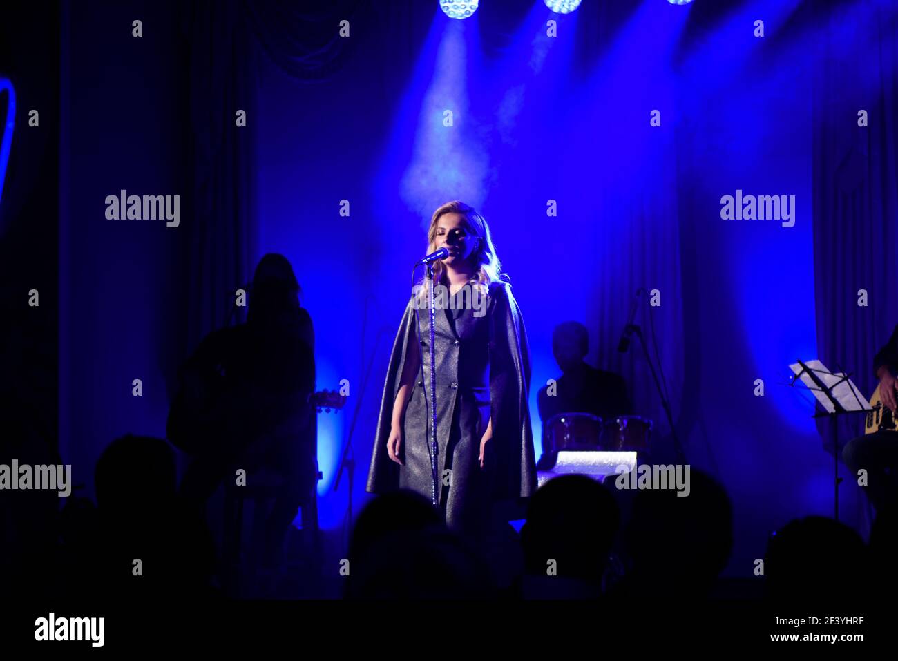 Female singer, performing her vocal sound. With lens flare and ...
