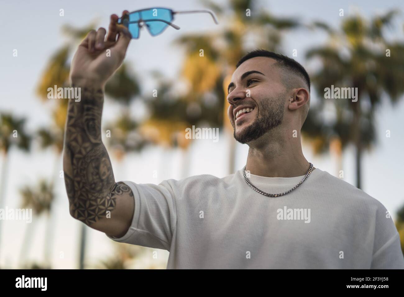 A shallow focus shot of a handsome Spanish Caucasian man with tattoos ...