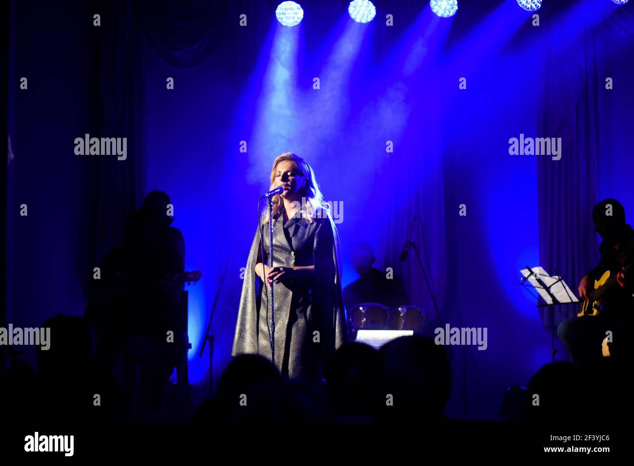 Female singer, performing her vocal sound. With lens flare and ...