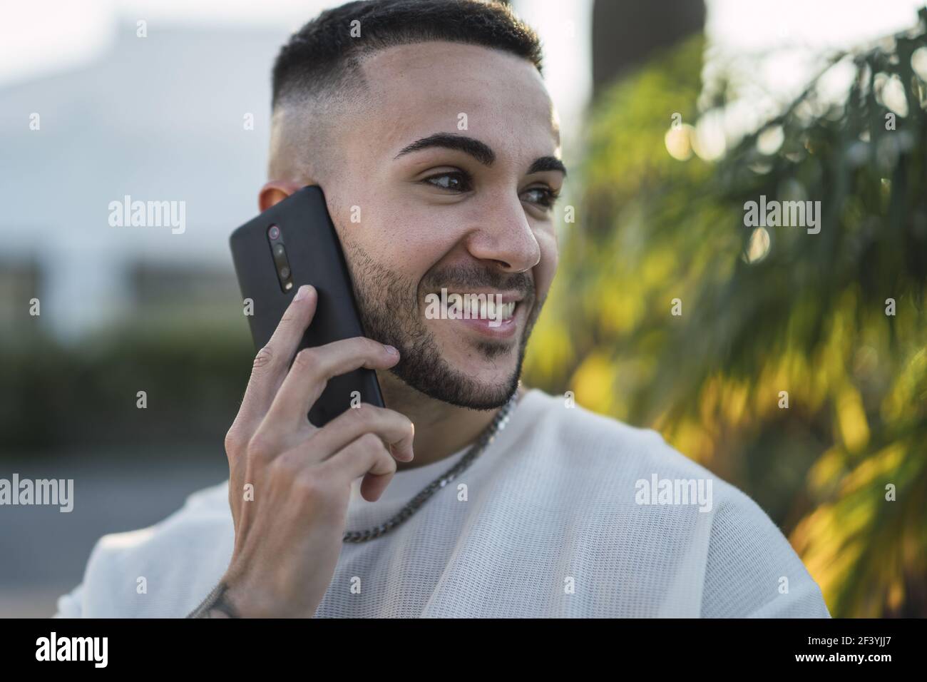A shallow focus shot of a handsome Spanish Caucasian man happily ...