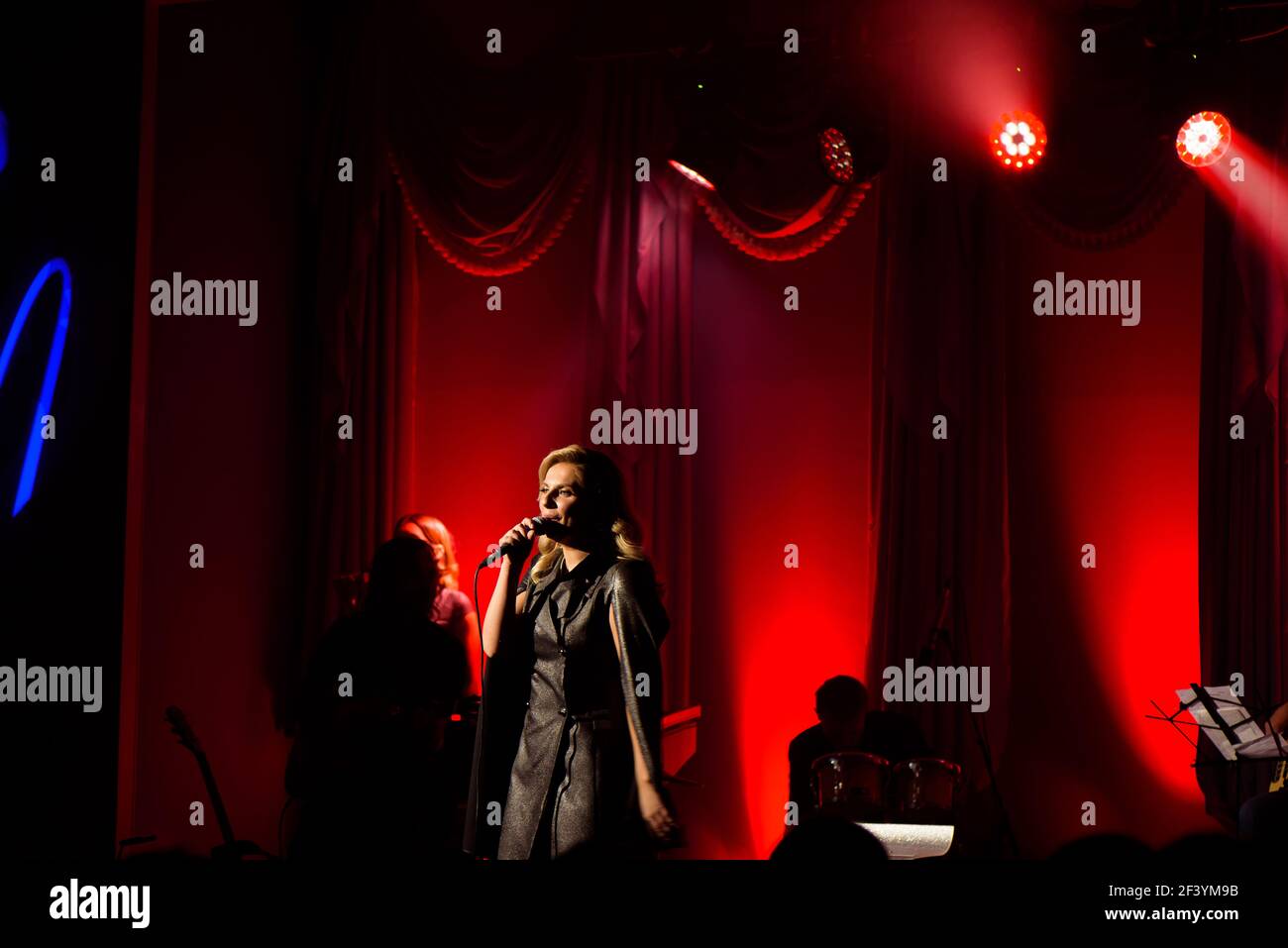 Singer with her band performing on stage. Concert. View from the ...