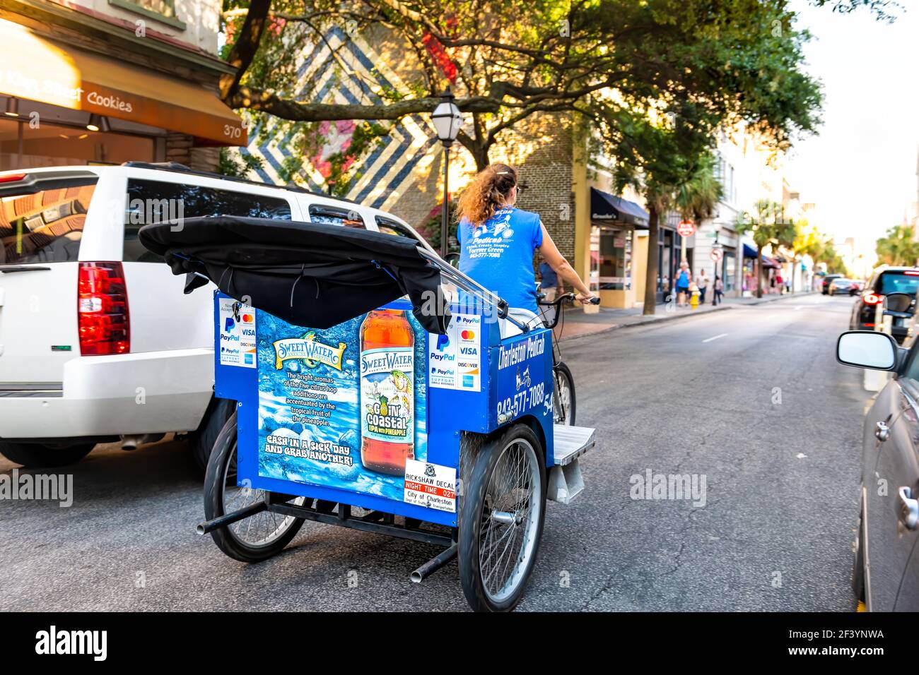 Charleston, USA - May 12, 2018: Woman riding guided tour rickshaw at ...