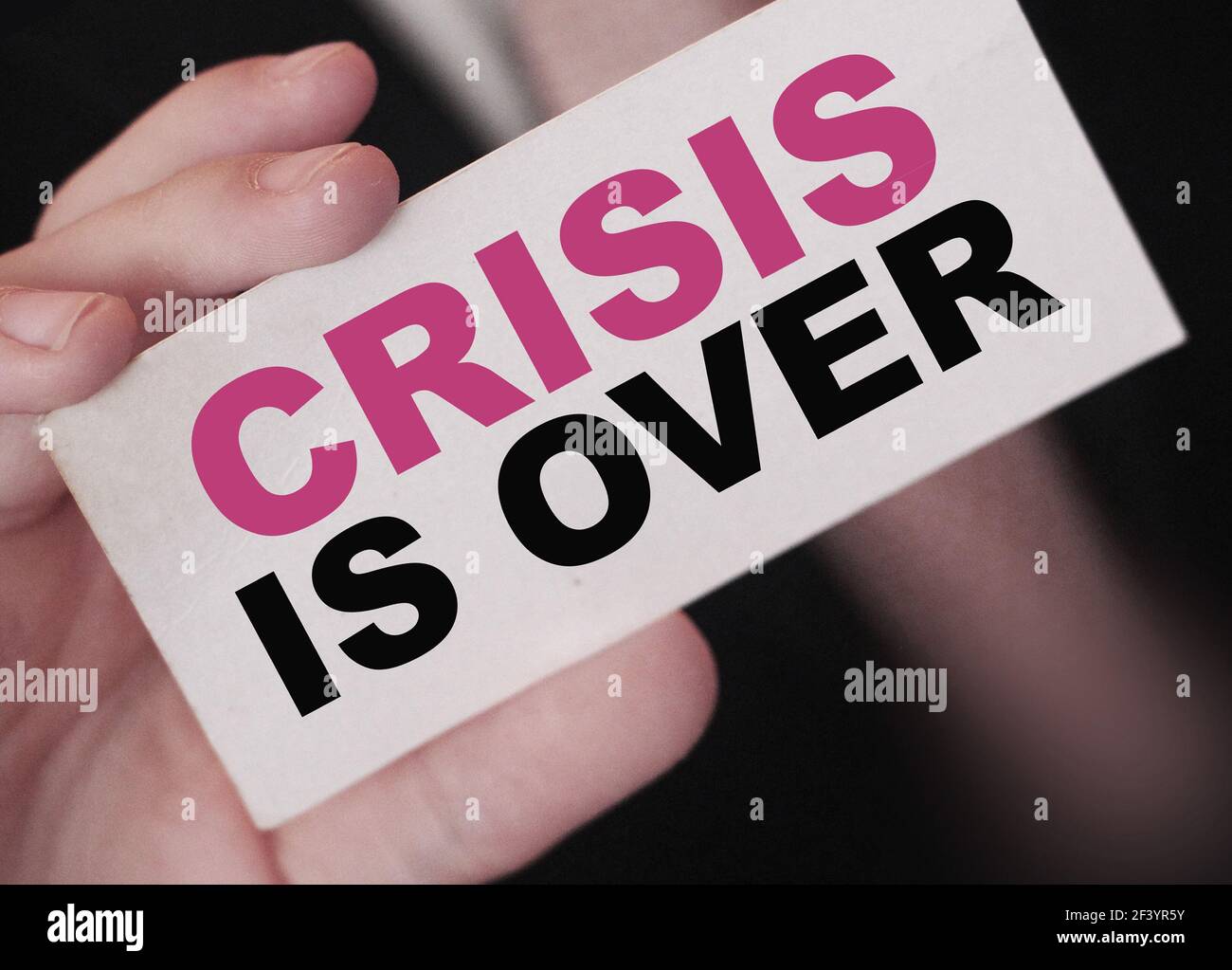 Crisis is over words on card Businessman is holding. Word Crisis, risk ...