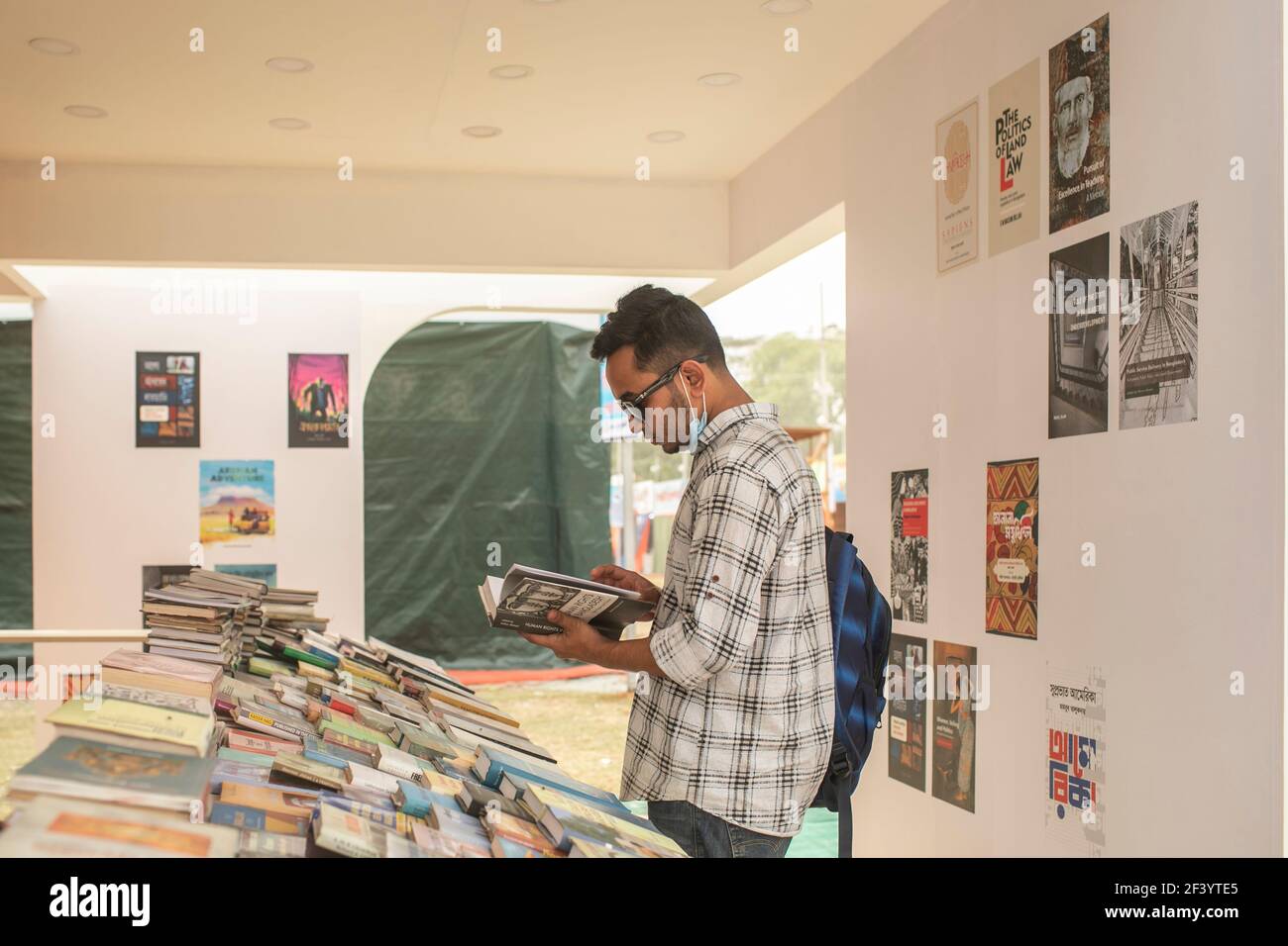 A visitor reading through a book at a stall during the fair.Inaugurated ...