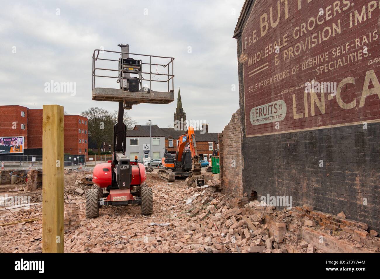 telescopic boom lift or mobile access platform in front of Ghost sign ...