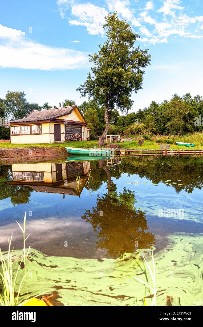 Fishing boats and wooden bath on the bank of the lake in summer. Nature ...