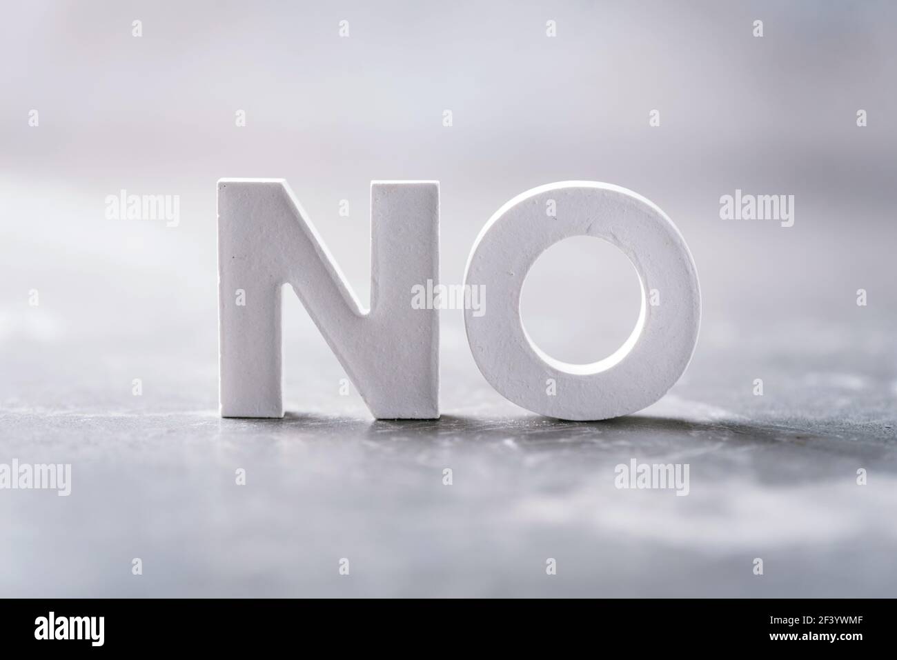 Word NO made with cement letters on grey marble background. Copy space ...