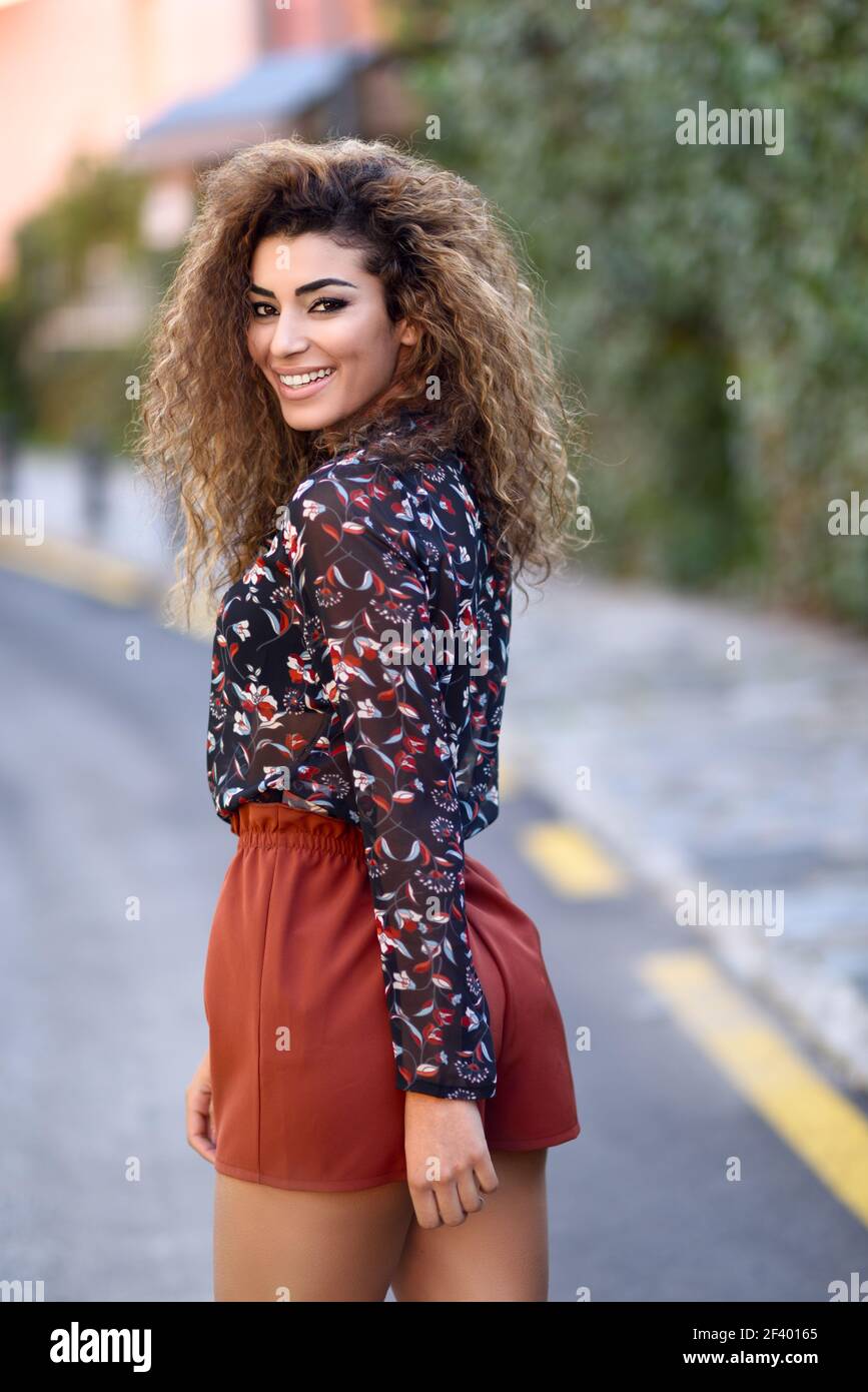Happy young arabic woman with black curly hairstyle.. Happy young ...