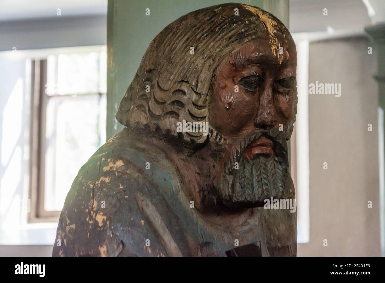 Old wooden pauper statue called Bartimeus of medieval stone church of ...