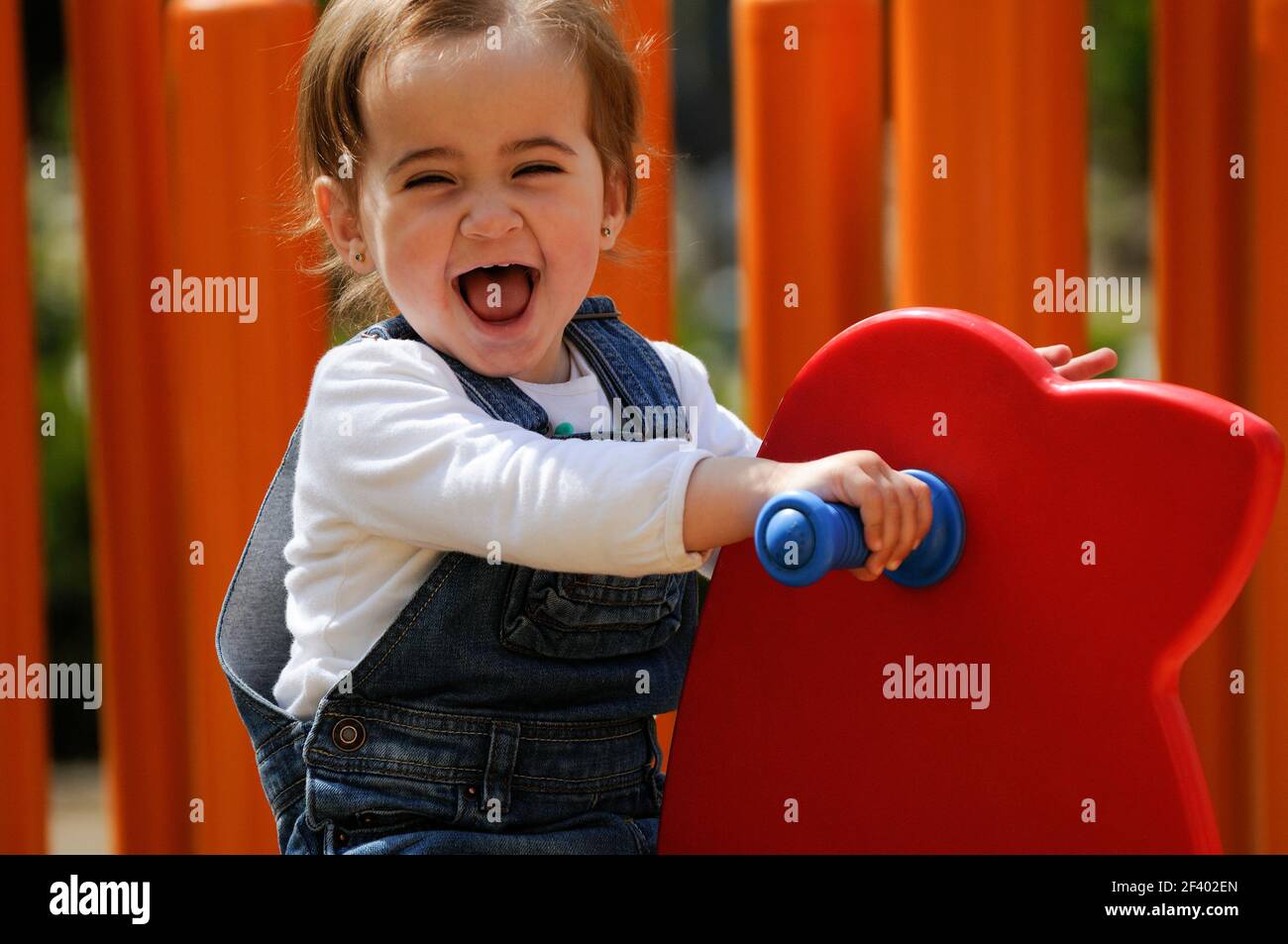 Happy little girl playing in a urban playground Stock Photo - Alamy