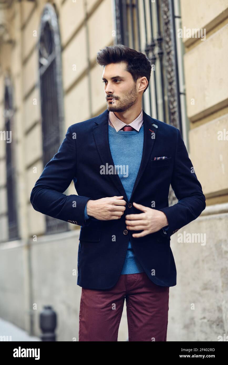 Attractive man in the street wearing british elegant suit. Young ...