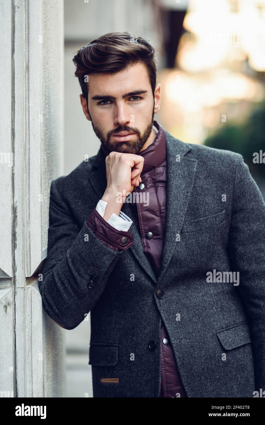 Young bearded man, model of fashion, in urban background wearing ...