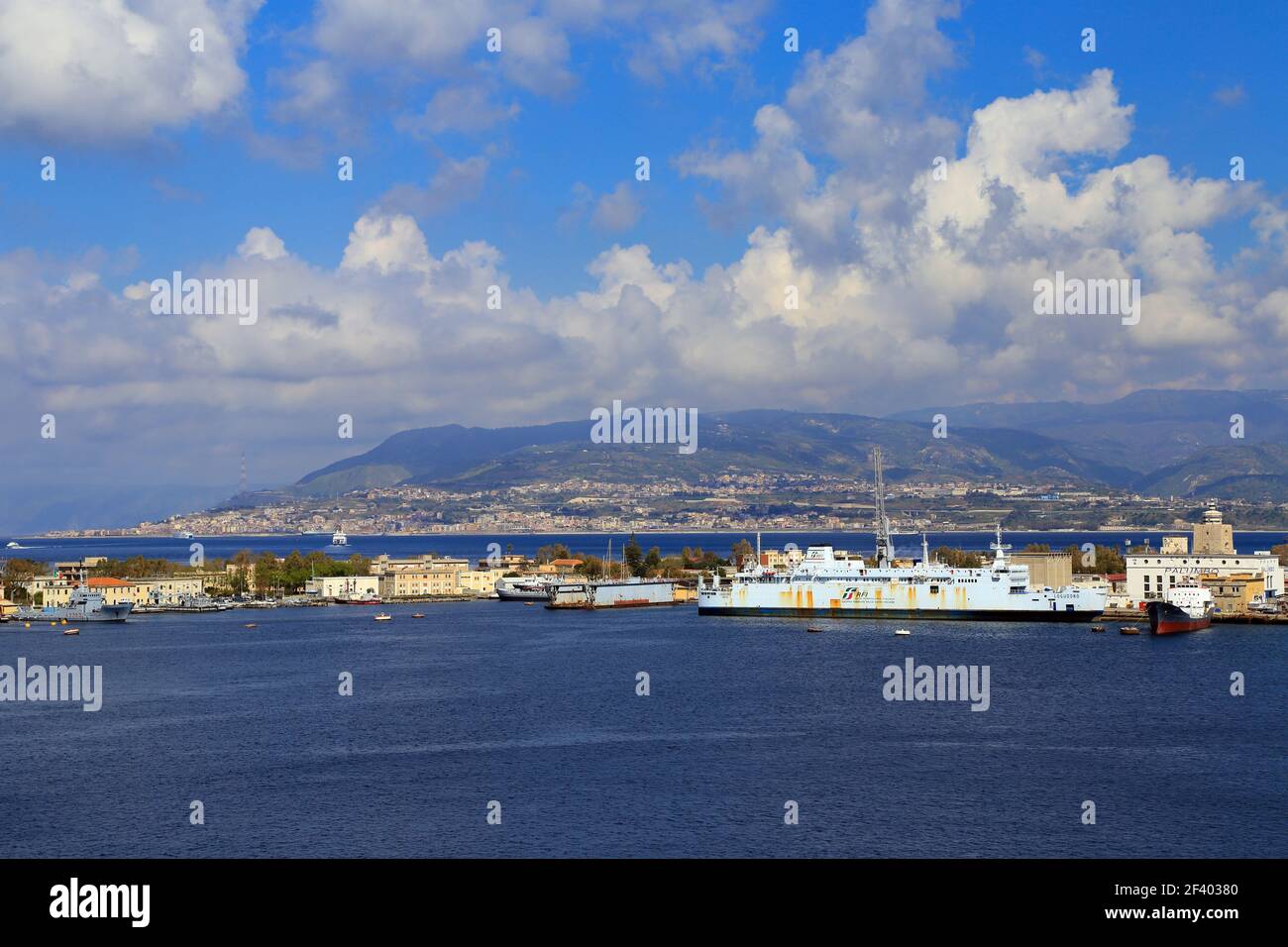 Messina harbour with a view across the Strait of Messina to the ...