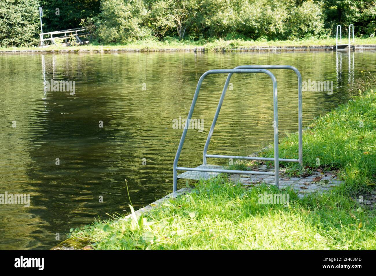 Natural swimming pool in the forest in Bavaria in summer photographed ...