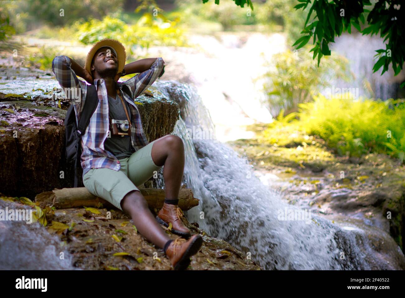 African traveler man sitting and relaxing freedom with waterfall Stock ...