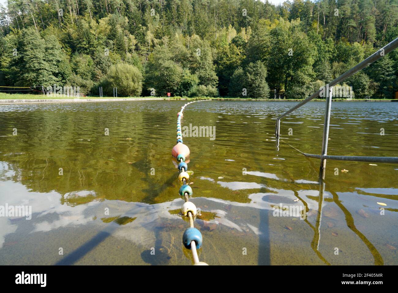 Natural swimming pool in the forest in Bavaria in summer photographed ...