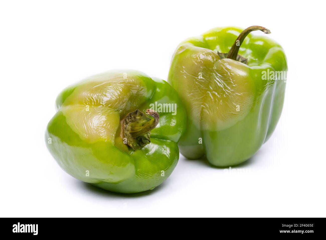 Rotten green bell pepper isolated on white background Stock Photo - Alamy