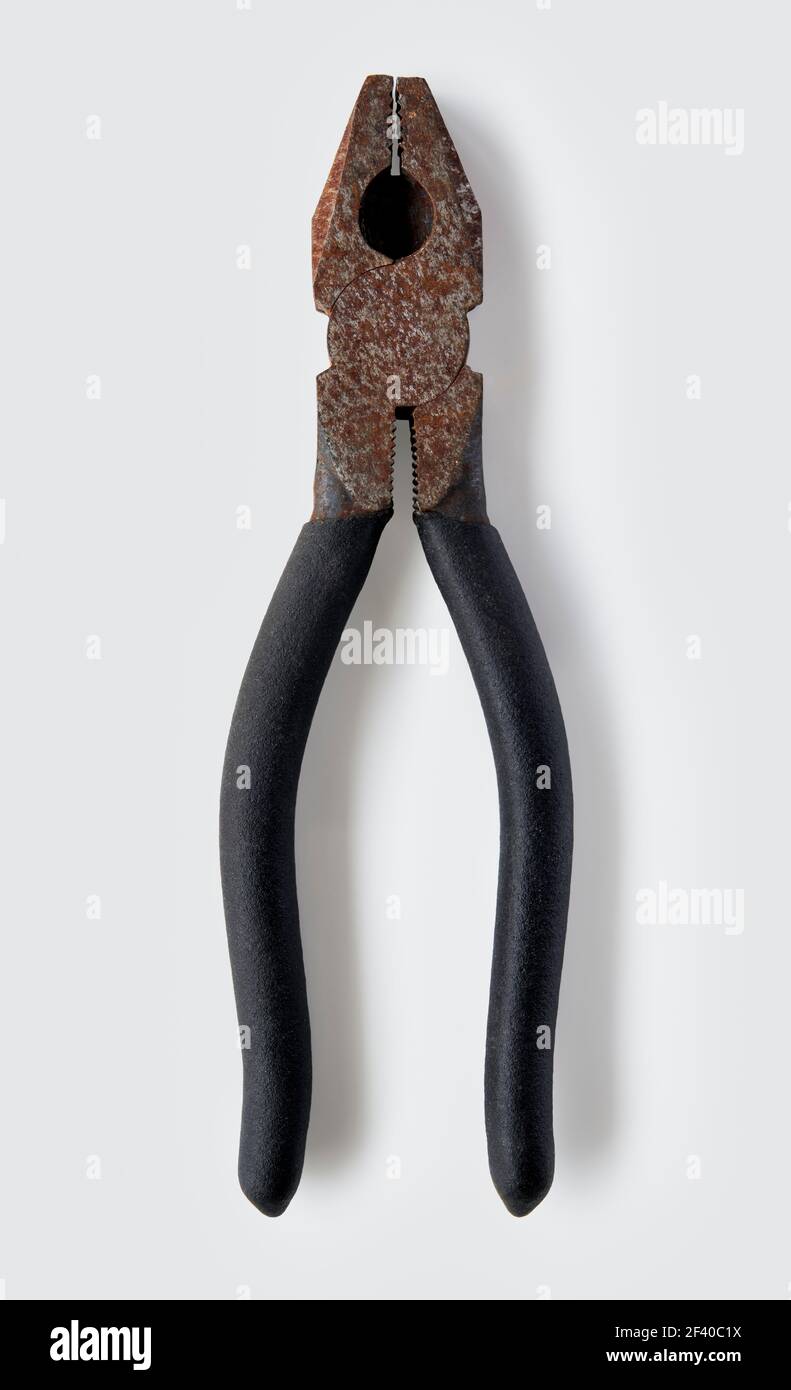 Overhead view of a pair of rusty pliers isolated on white background ...