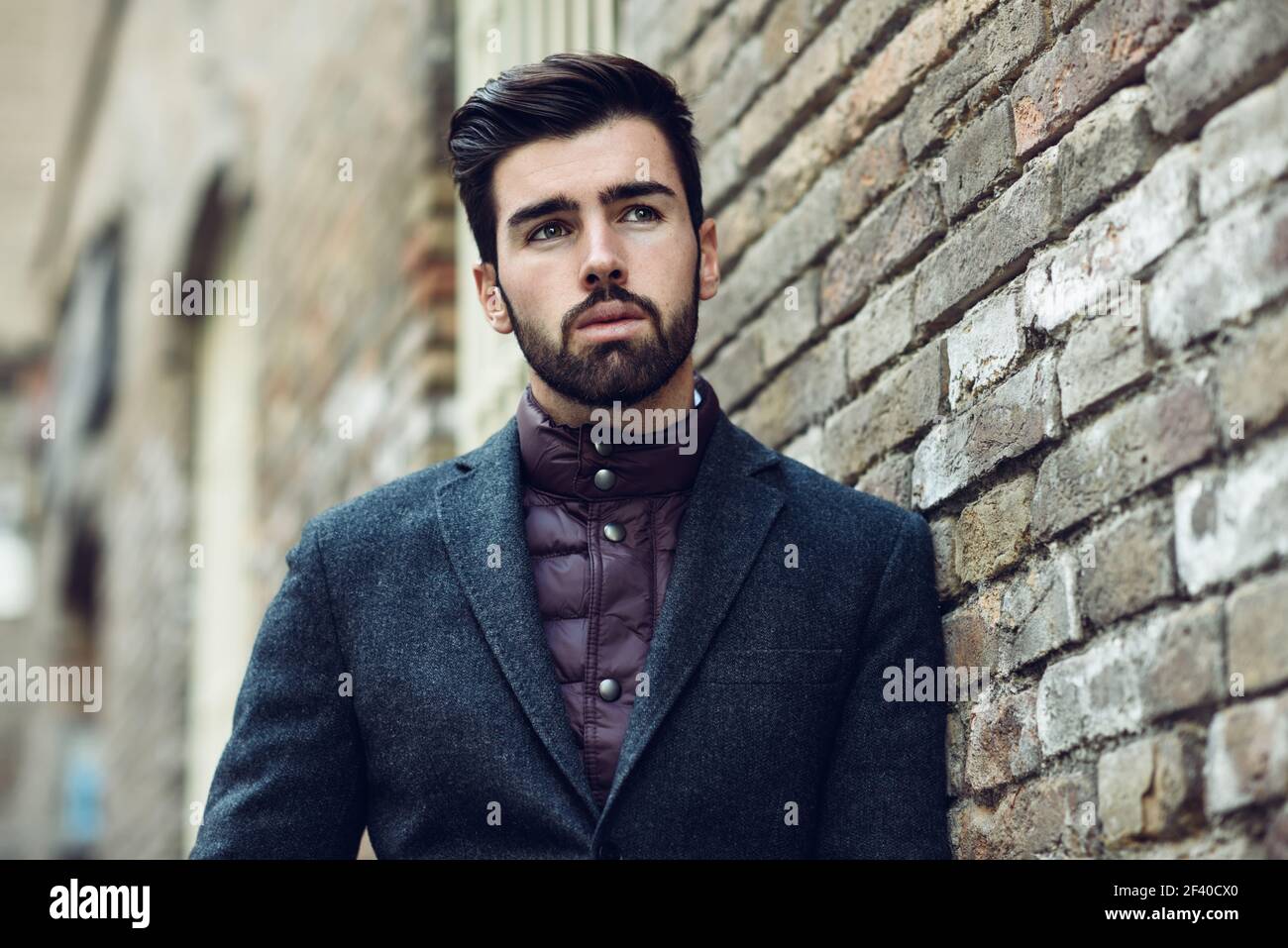 Young bearded man, model of fashion, in urban background wearing ...