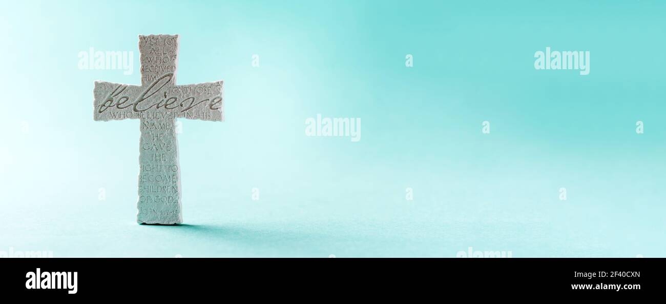 Stone cross with inscription Believe on grey background, Copy space ...