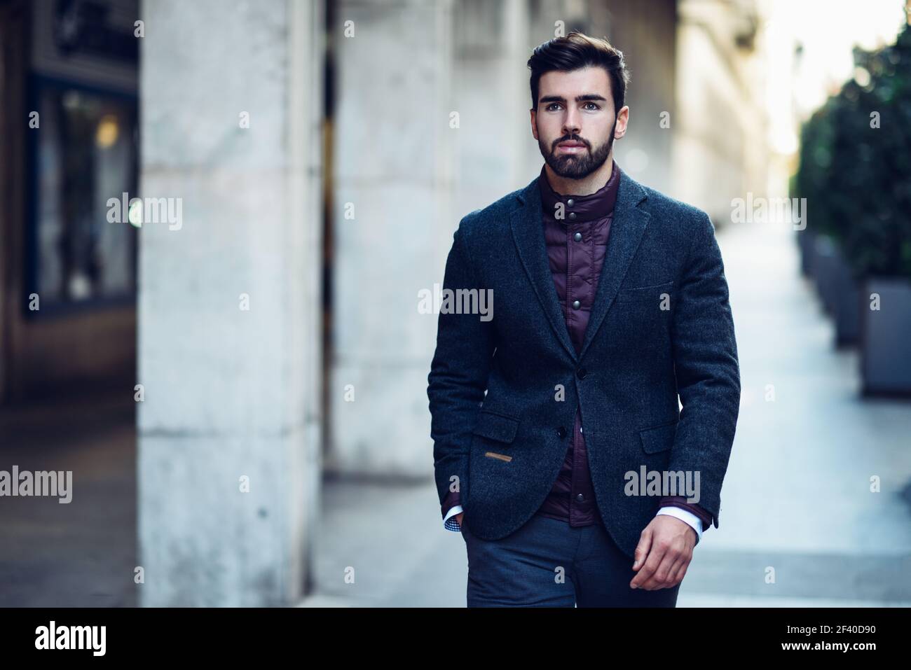 Young bearded man, model of fashion, in urban background wearing ...