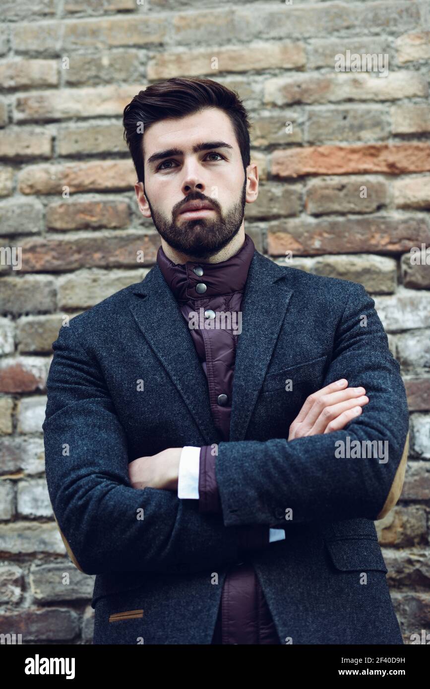 Young bearded man, model of fashion, in urban background wearing ...