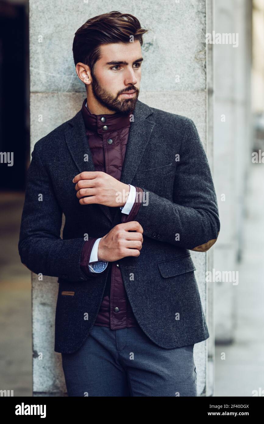 Young bearded man, model of fashion, in urban background wearing ...