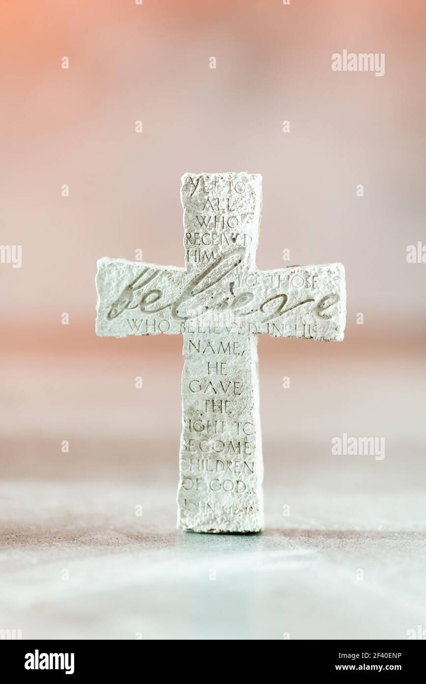 Stone cross with inscription Believe on grey background, Copy space ...