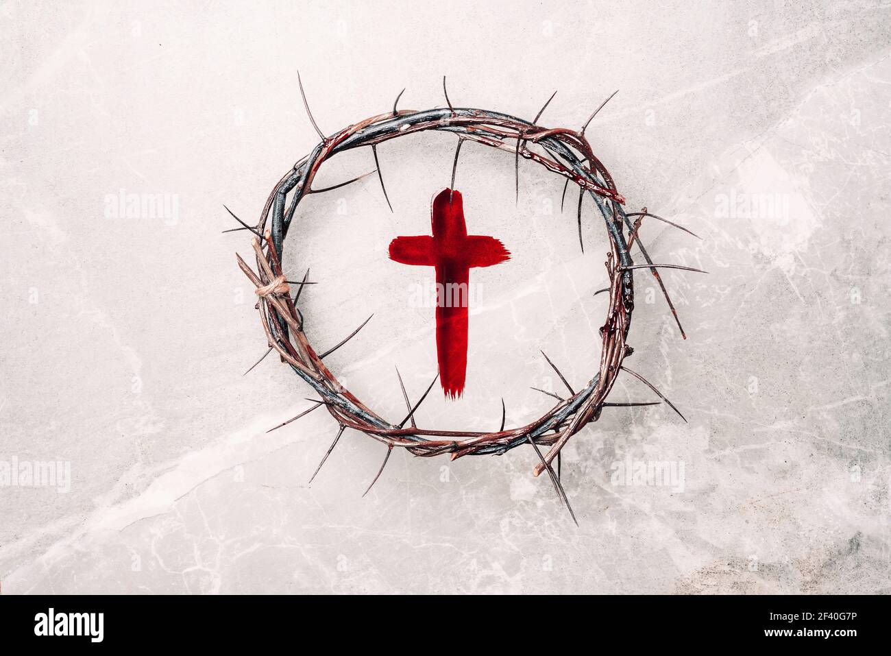 Crown of thorns, cross painted with red blood on stone background. Copy ...