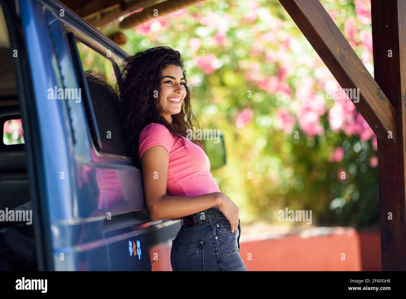 Young woman in a camper van enjoying spring time in a beautiful camping ...
