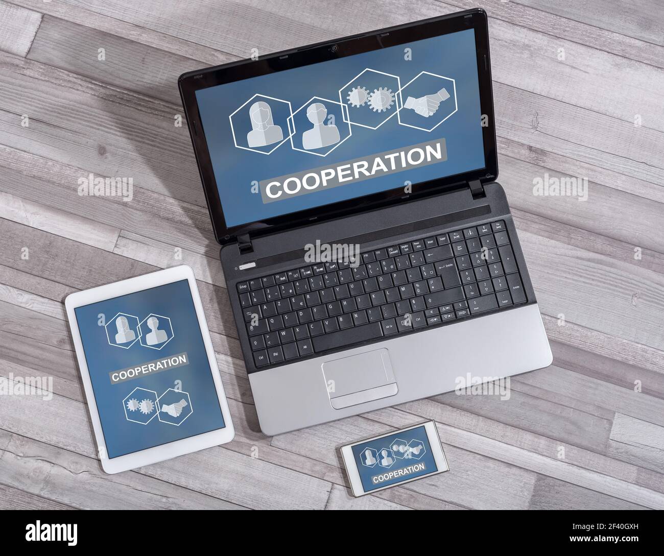Cooperation concept shown on different information technology devices ...