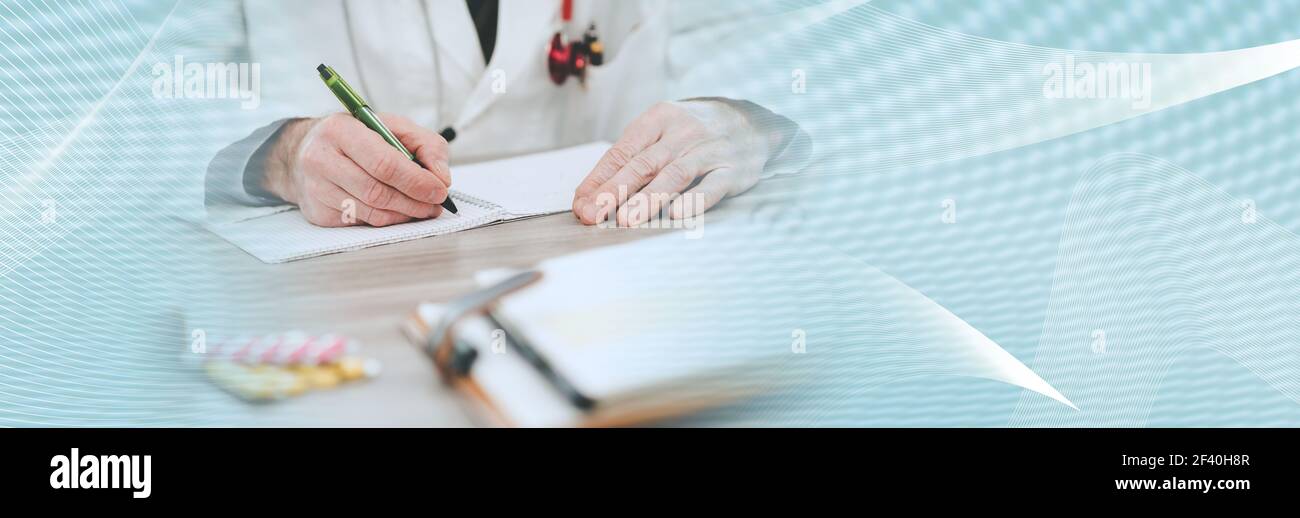 Doctor sitting at desk and taking notes; panoramic banner Stock Photo ...