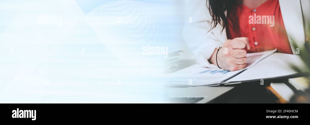 Angry businesswoman hitting her desk with her clenched fist; panoramic ...
