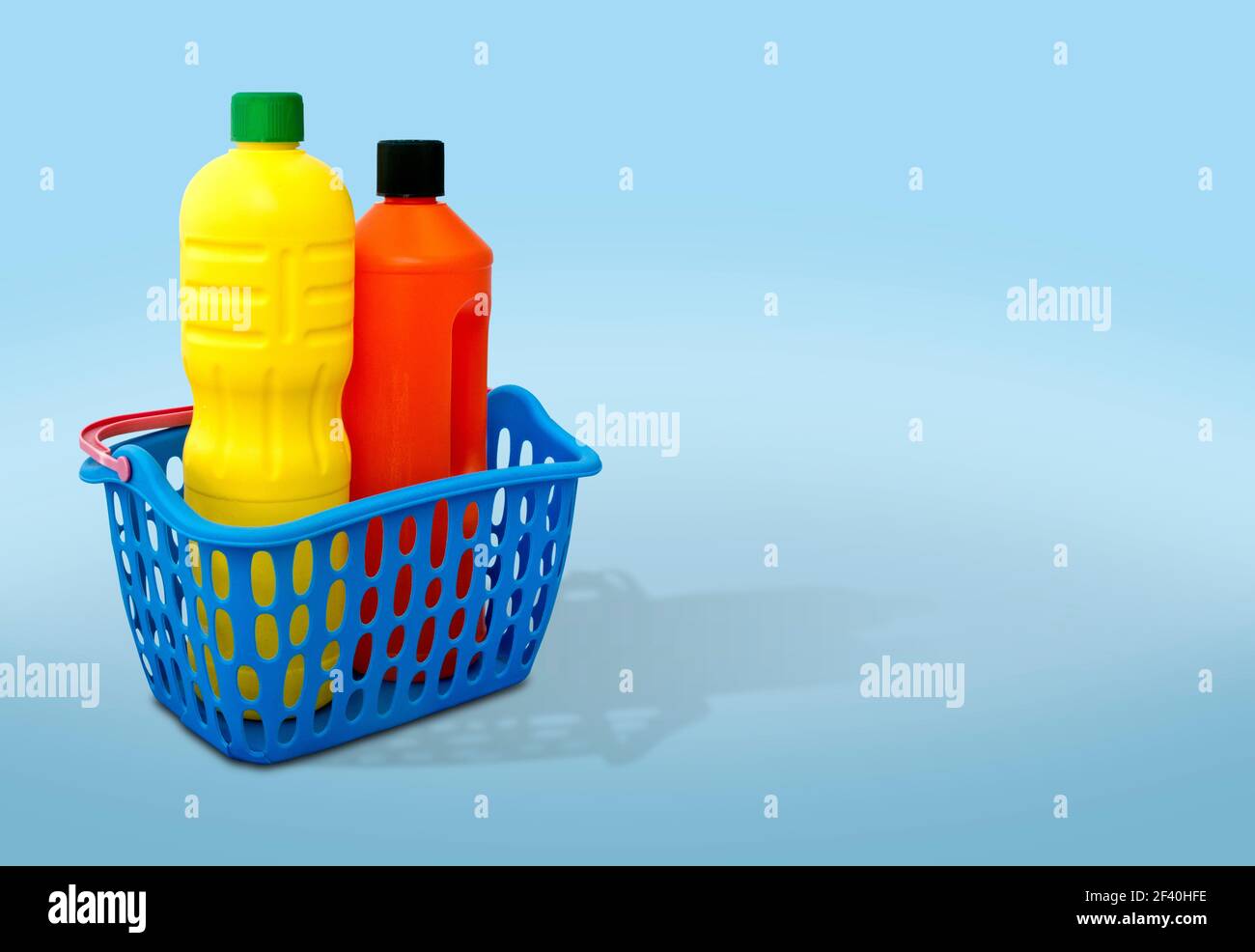 Cleaning supplies in plastic basket Stock Photo - Alamy