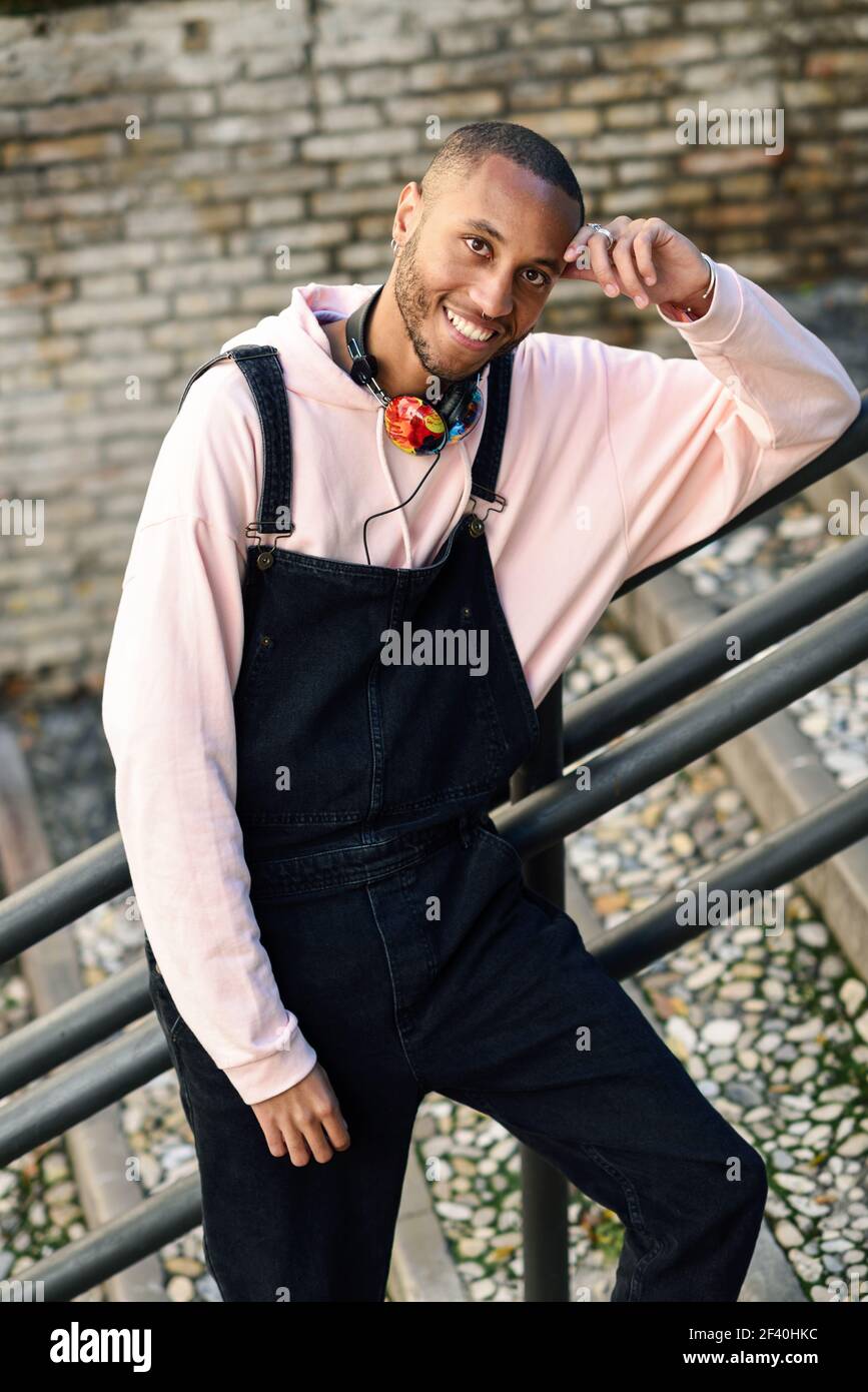 Young black man wearing casual clothes smiling on urban stairs. Happy ...