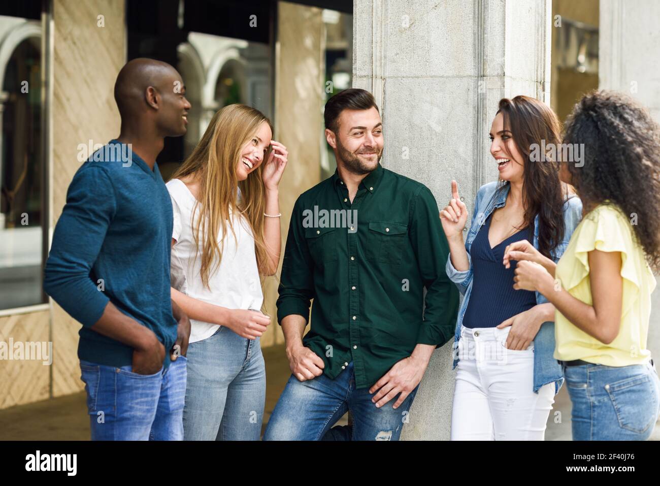Multi-ethnic group of young people having fun together outdoors in ...
