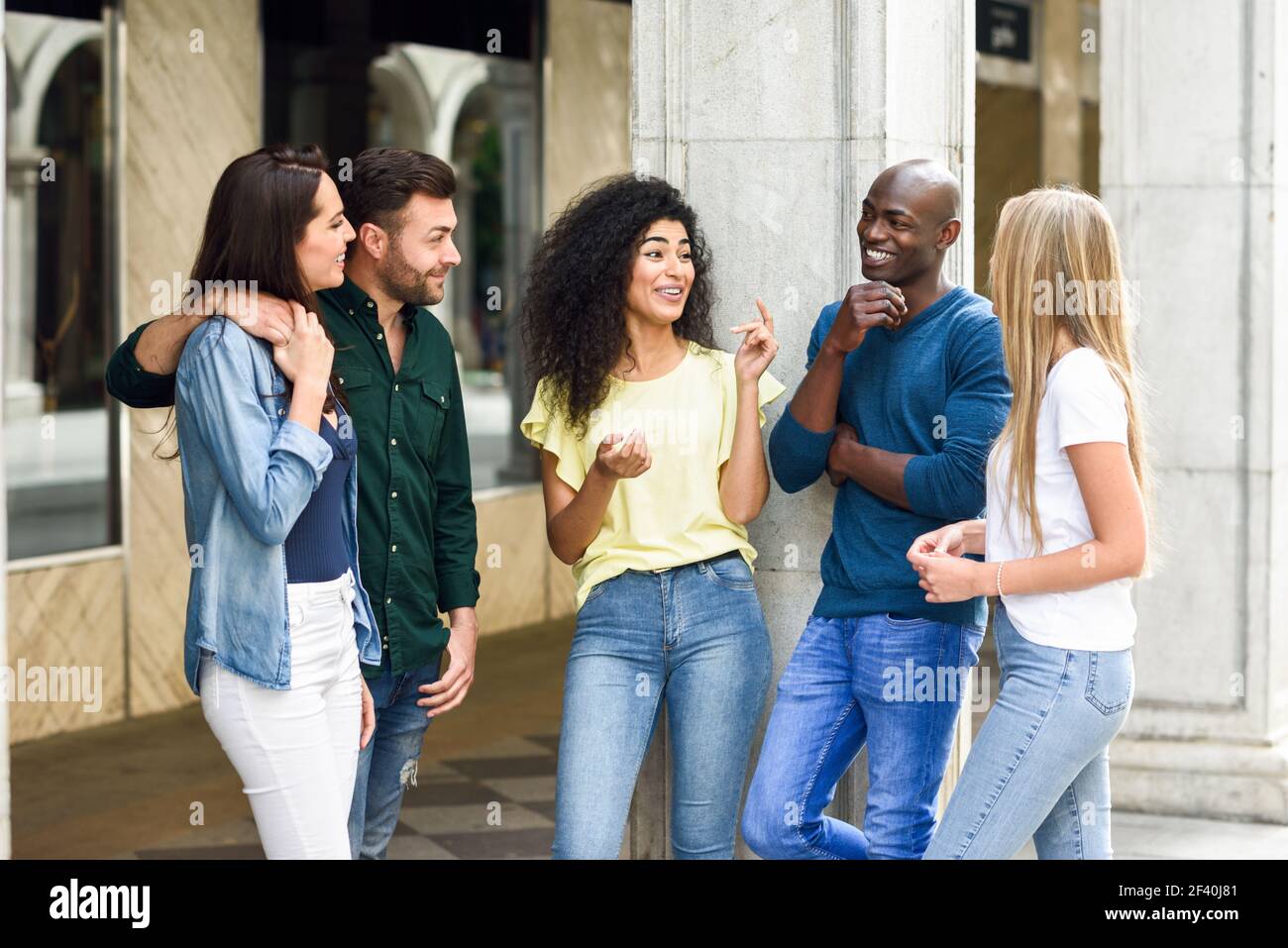 Multi-ethnic group of young people having fun together outdoors in ...