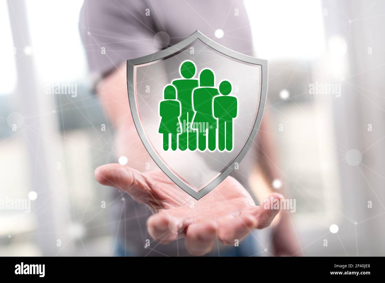 Family protection concept above the hand of a man in background Stock ...