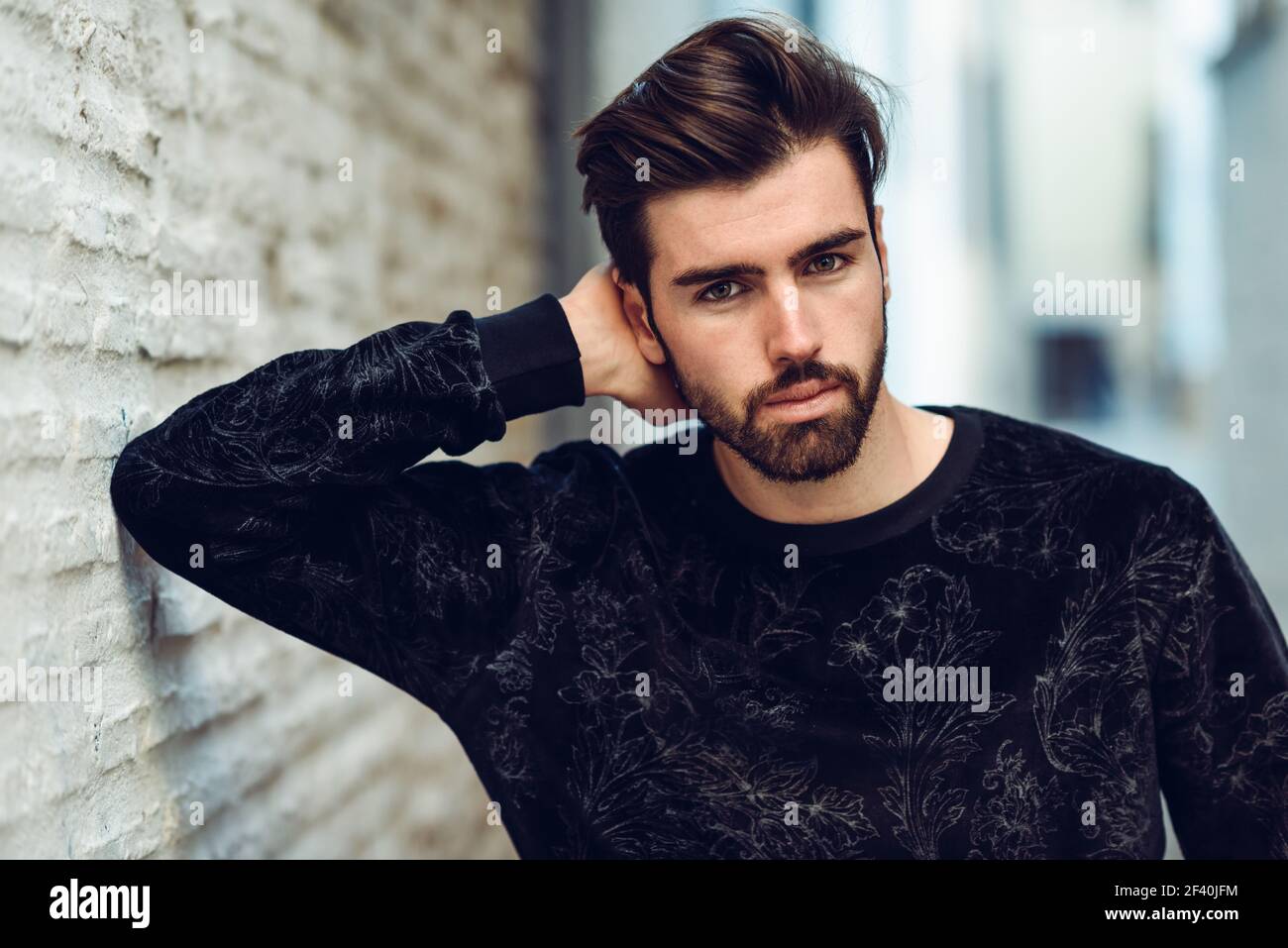 Young Bearded Man Model Of Fashion Looking At Camera In Urban