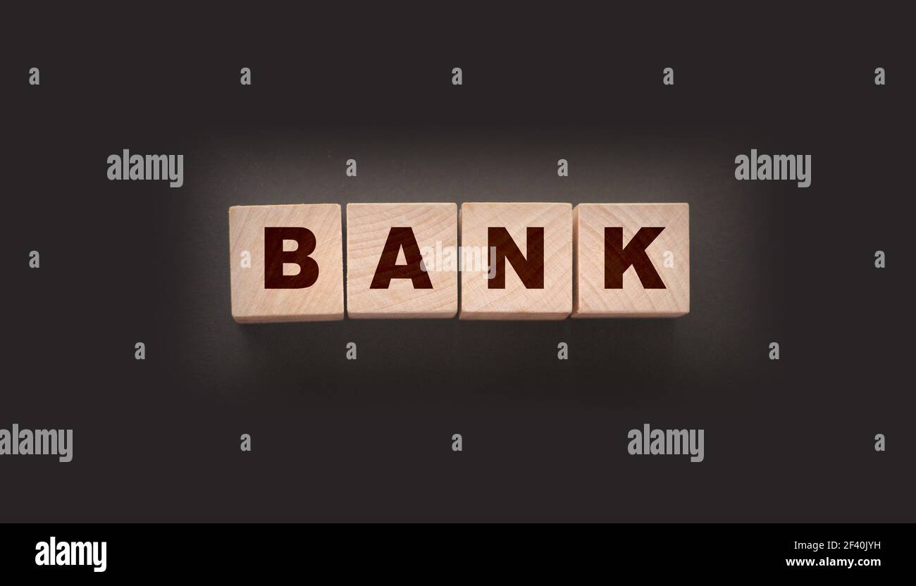 Bank word concept written on wooden cubes on black table. Banking ...