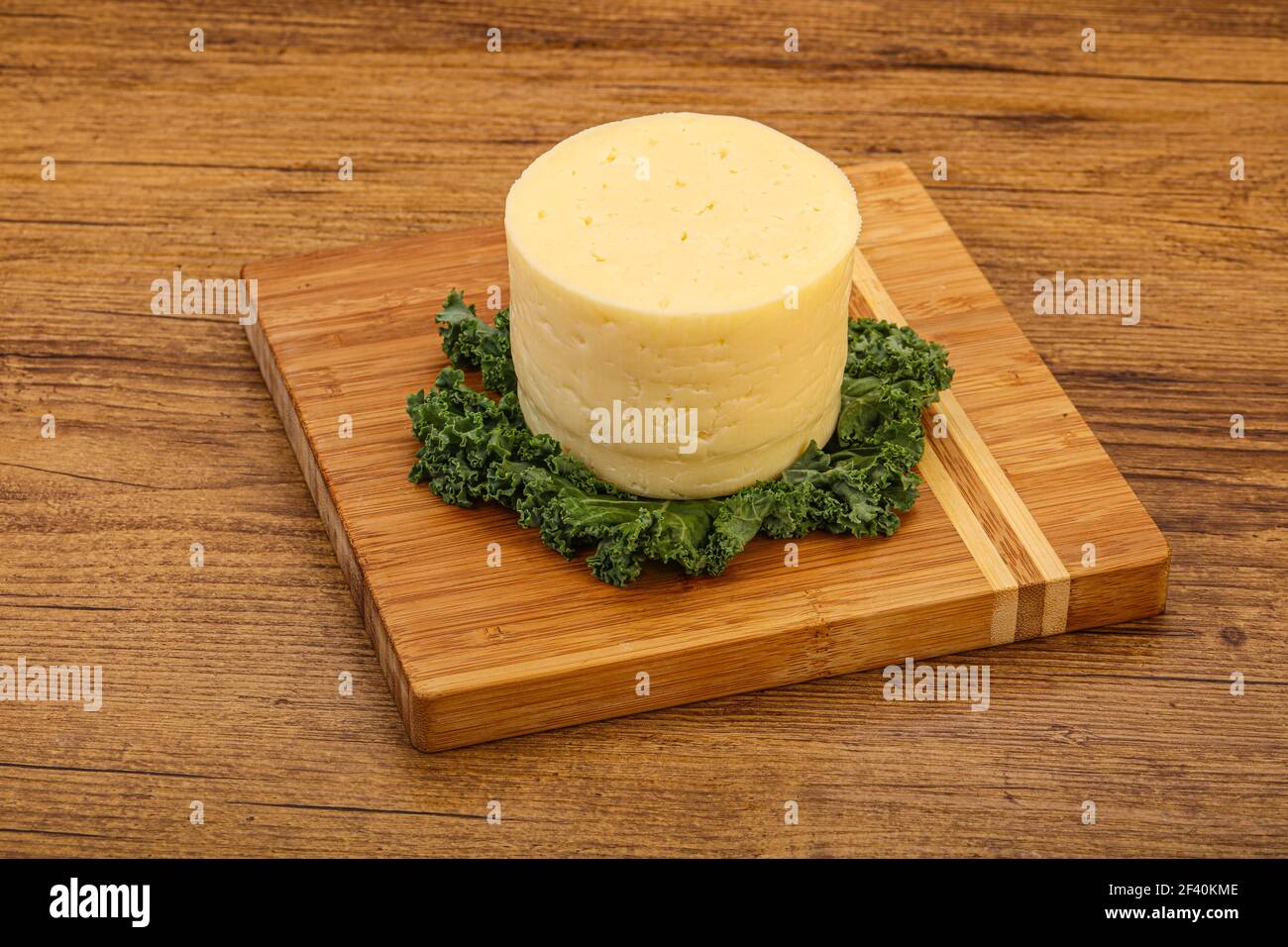 Yellow round dairy soft cheese piece Stock Photo - Alamy