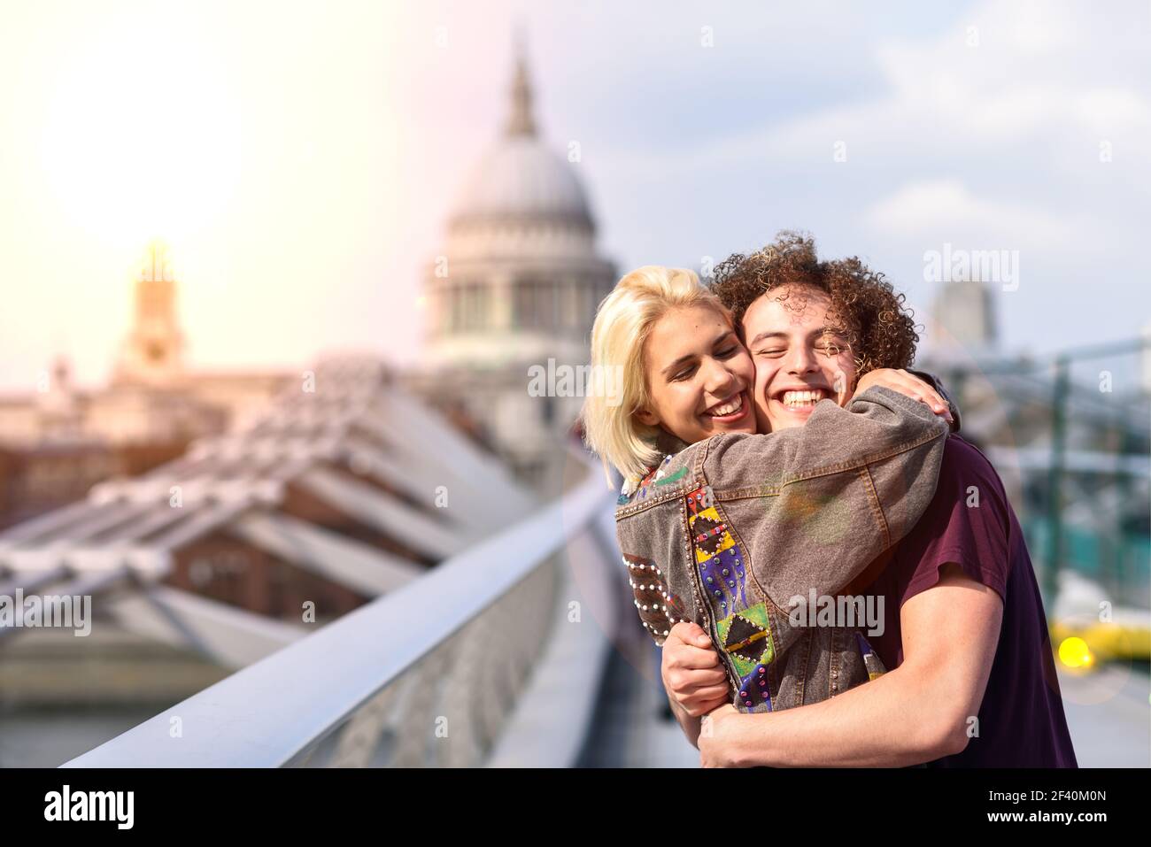 Happy couple hugging by Millennium bridge, River Thames, London. UK ...